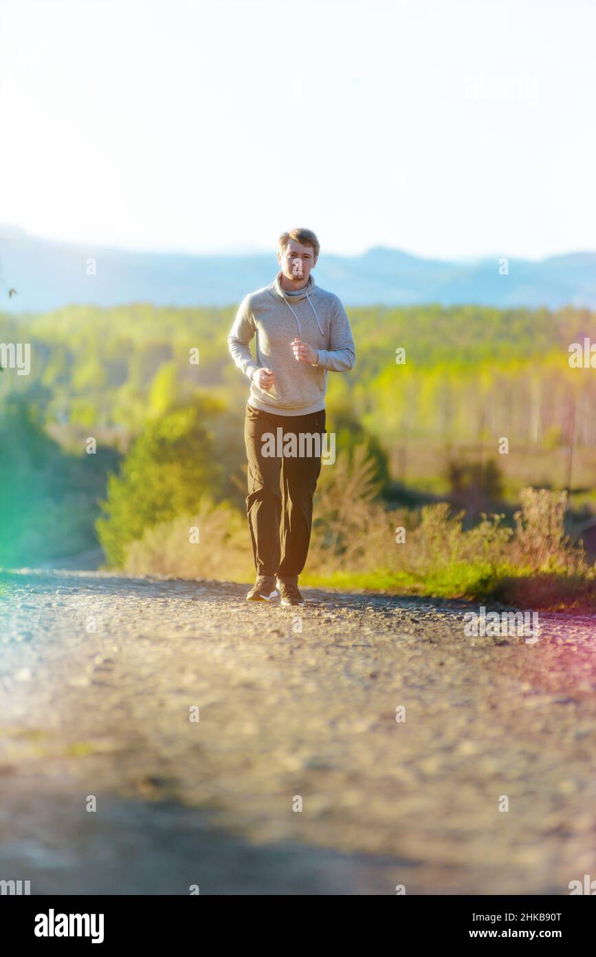 Running man jogging in rural nature at beautiful summer day. Sport ...