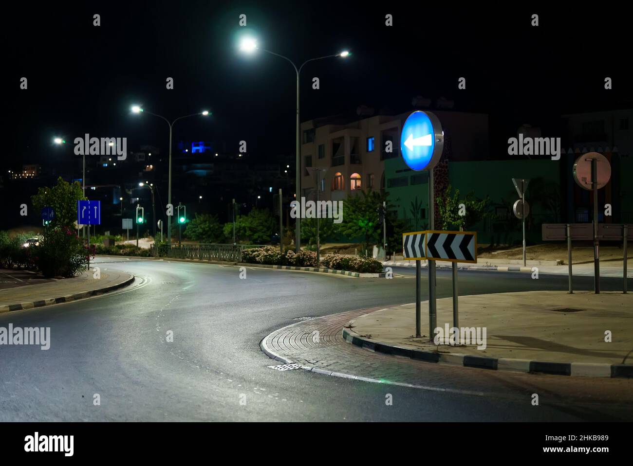 Modern roundabout intersection at night Stock Photo - Alamy