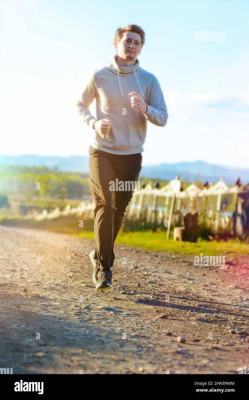 Running man jogging in rural nature at beautiful summer day. Sport ...