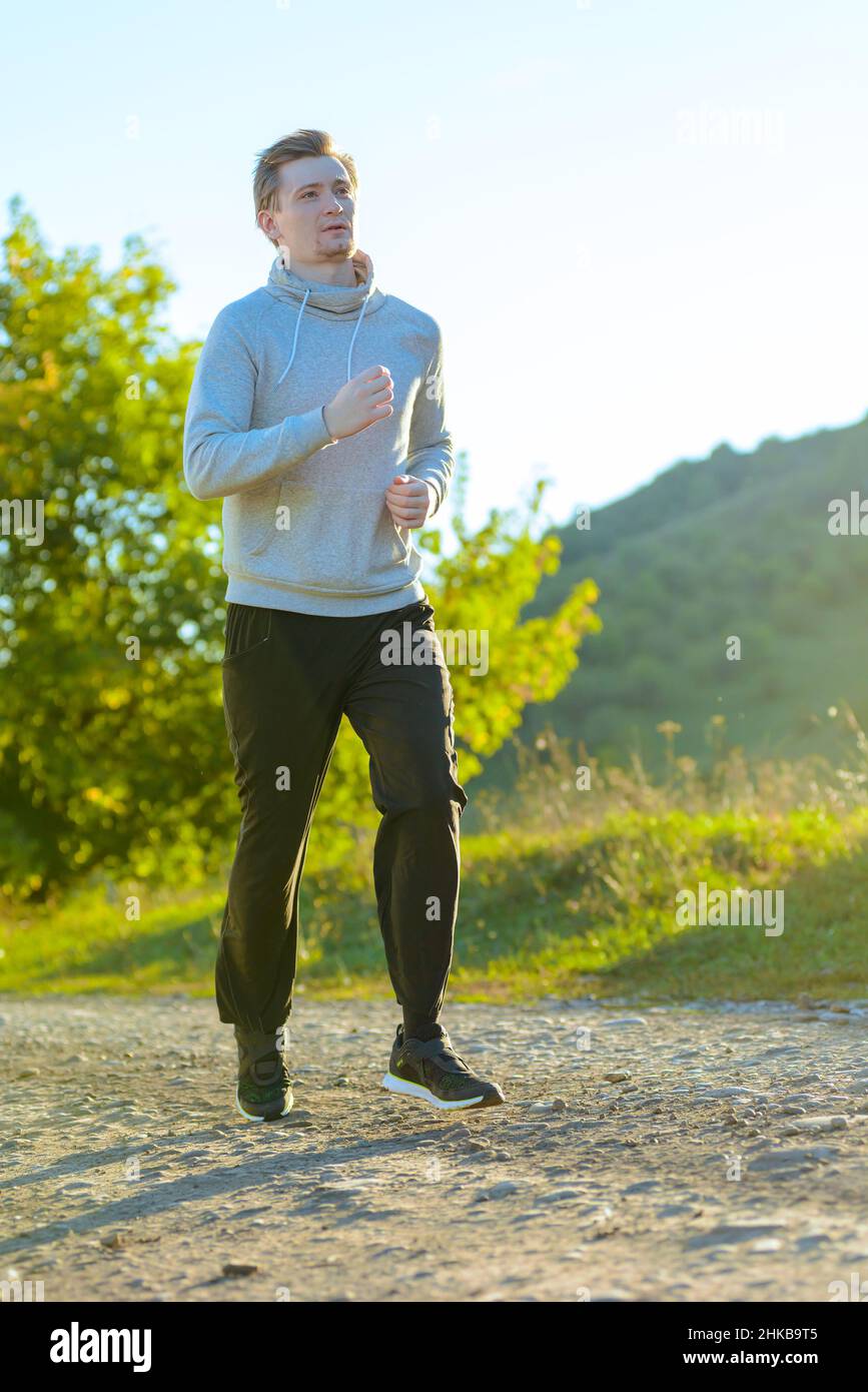 Running man jogging in rural nature at beautiful summer day. Sport ...