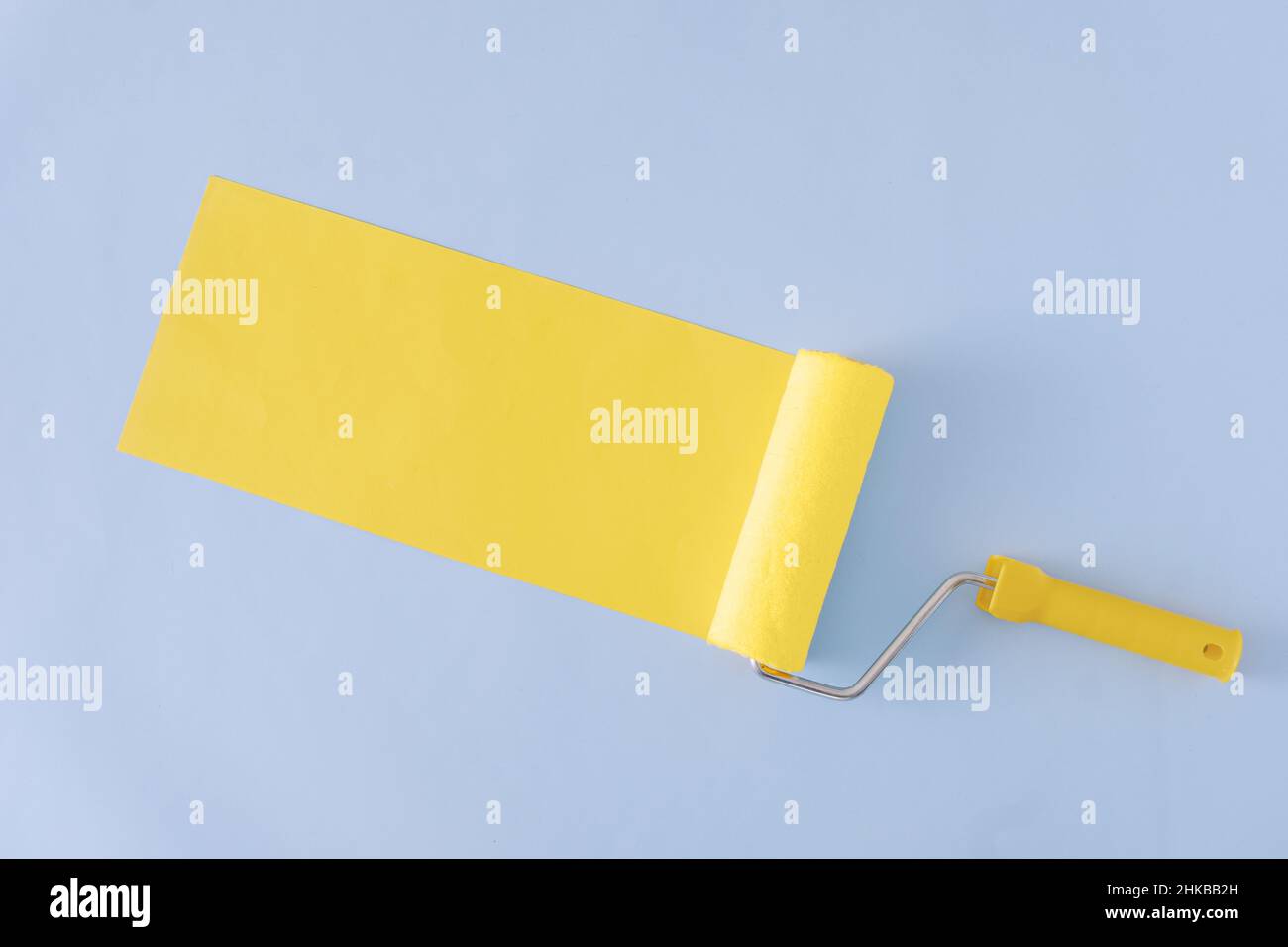 Yellow painted diagonal banner with paint roller effect and copy space ...