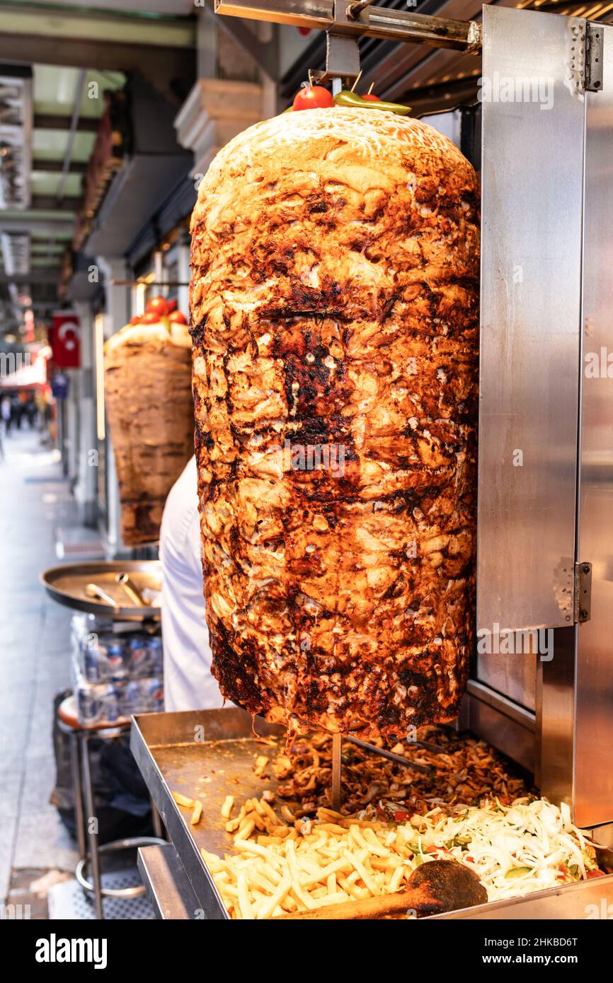 Grilled chicken meat on a vertical rotisserie used in traditional ...