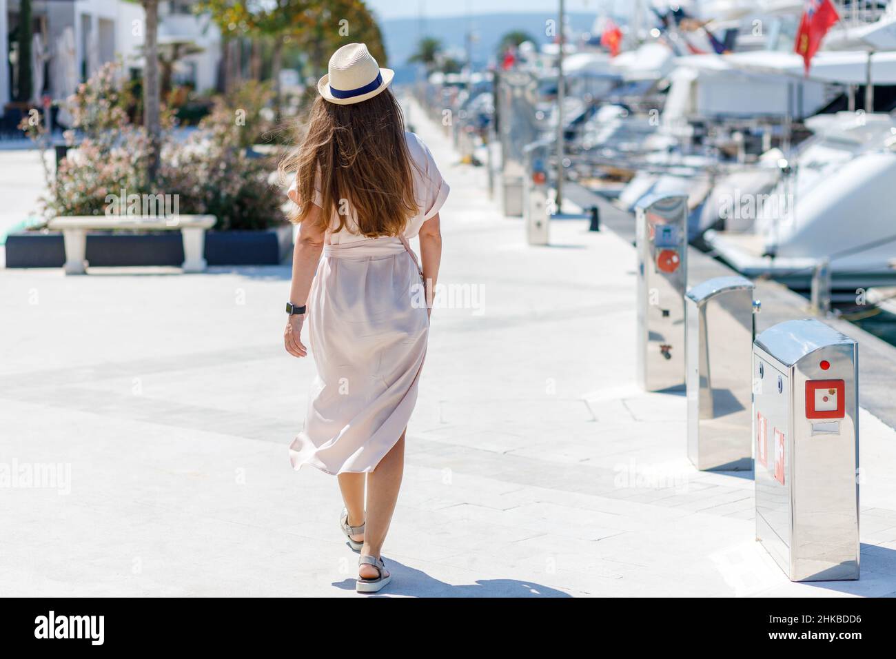 Young lady in dress walking by marina port in europe town Stock Photo ...