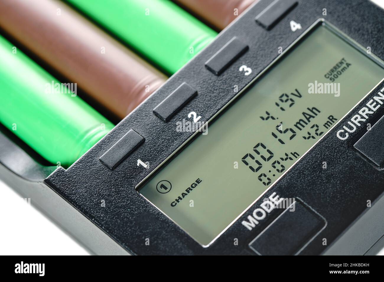 electronic charger with batteries close-up, background Stock Photo - Alamy