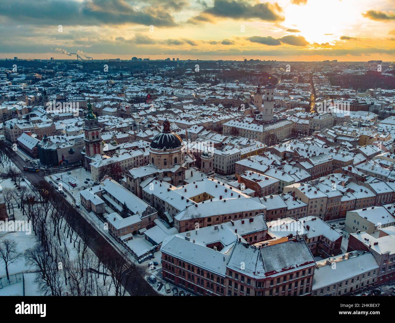 Aerial shot of Old City Lviv cowered by snow with churches and ...