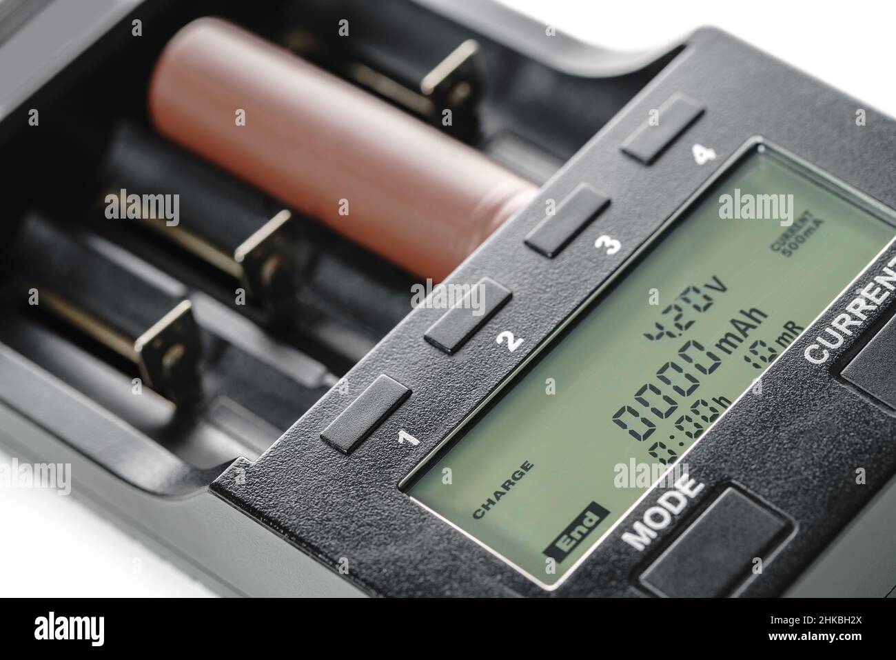 electronic charger with batteries close-up, background Stock Photo - Alamy