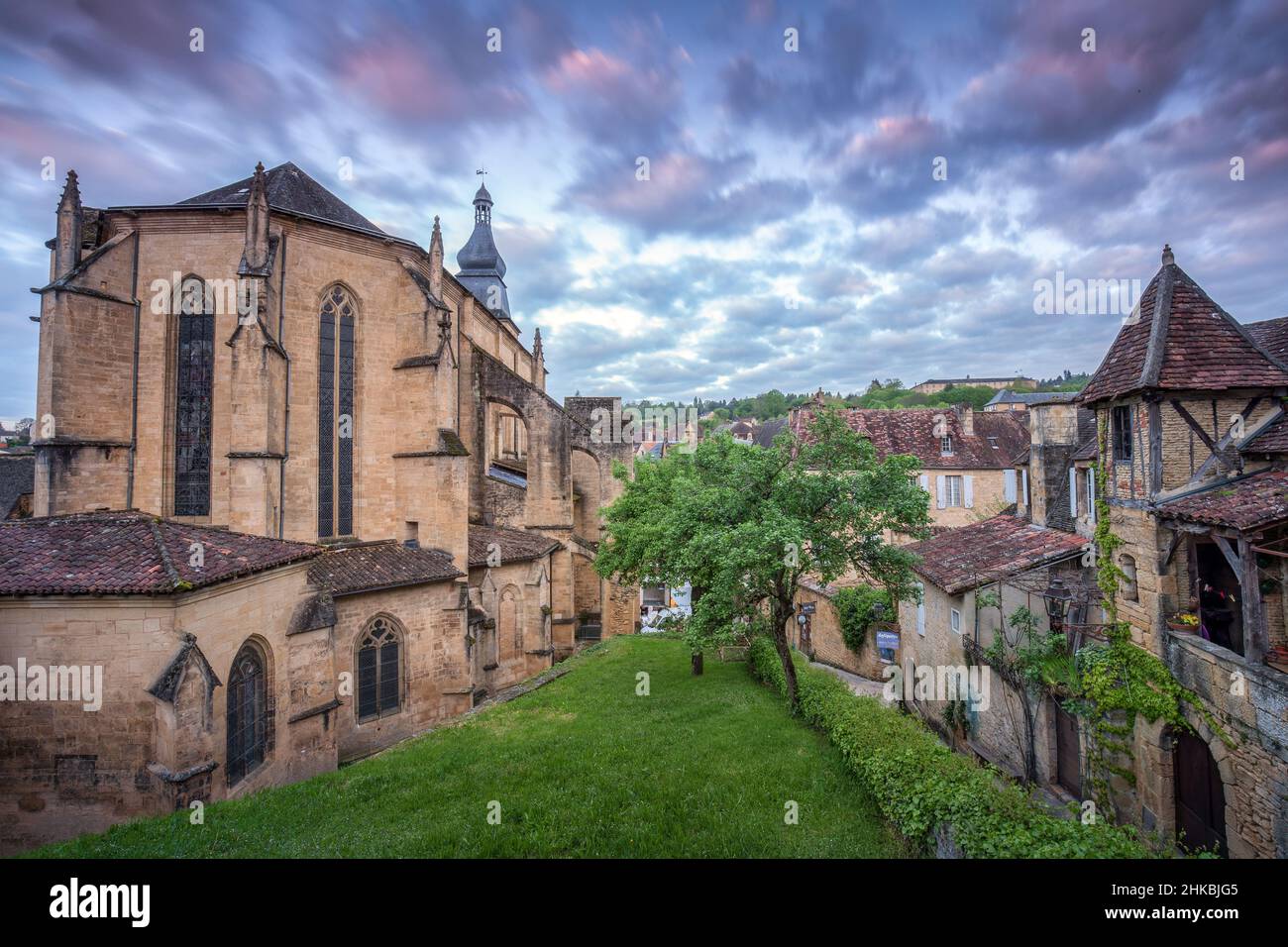 Sarlat Cathedral at sunrise with medieval architecture and stone houses ...