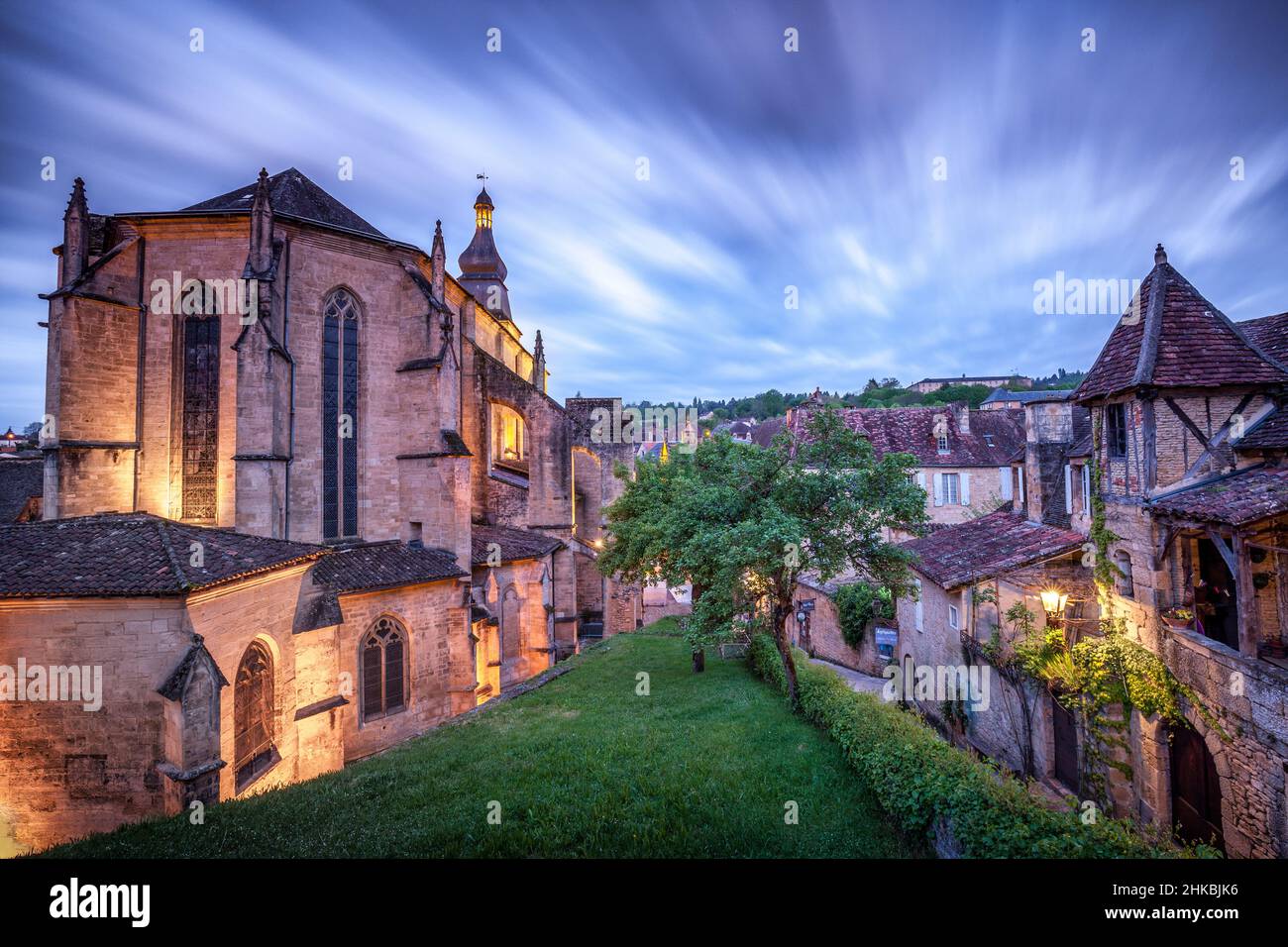 Sarlat Cathedral illuminated before sunrise with medieval architecture ...