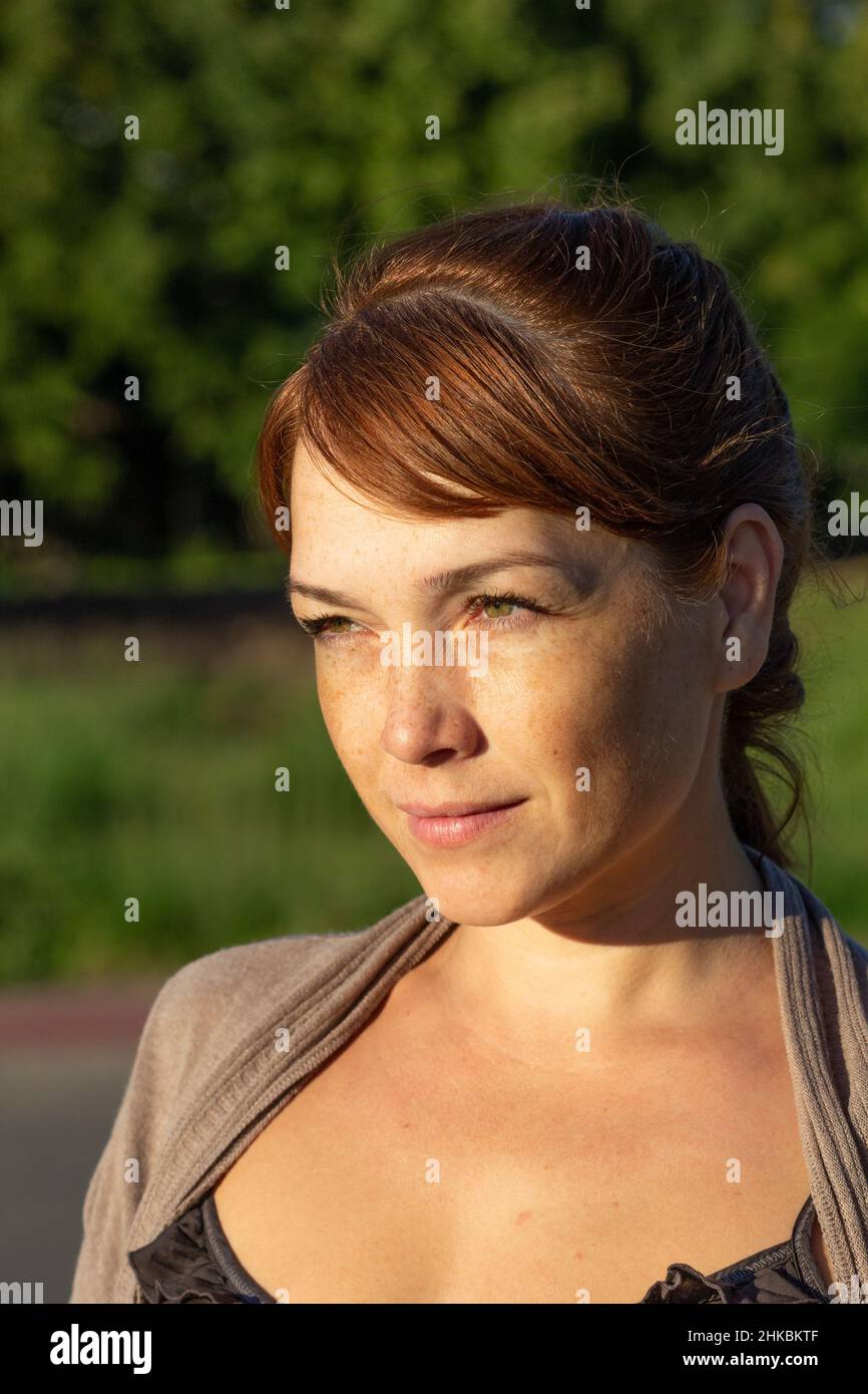 Portrait of beautiful serious middle-aged woman with calm face looking aside Stock Photo - Alamy