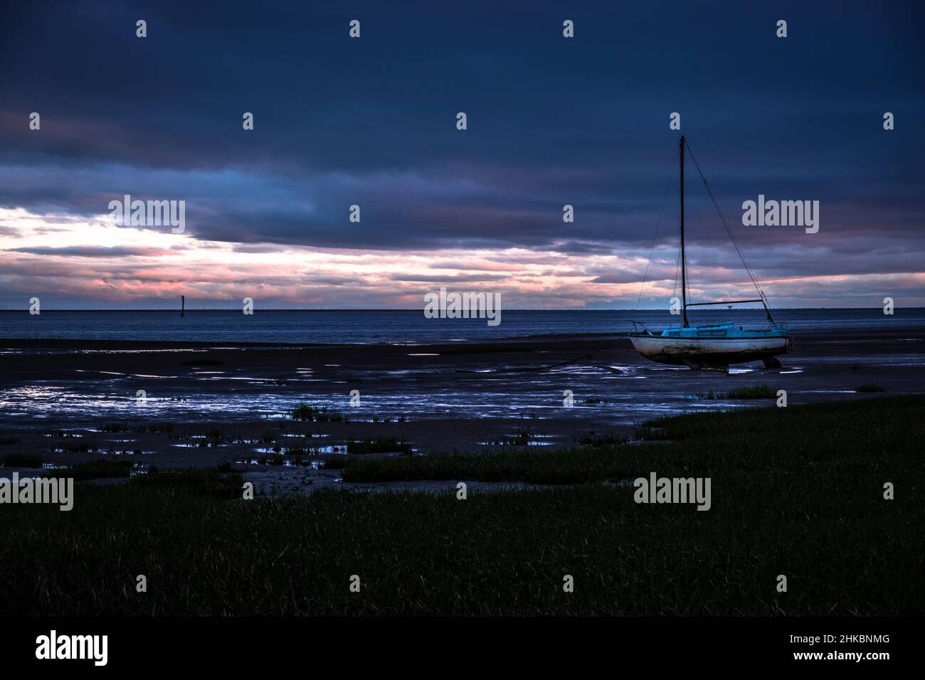 Stranded boat on the beach at night Stock Photo - Alamy