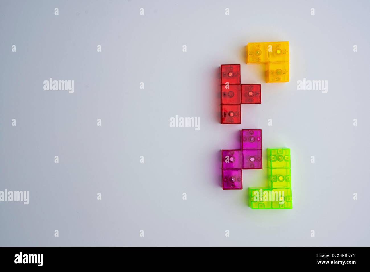 three-dimensional colored tetris figures on a white background, space ...