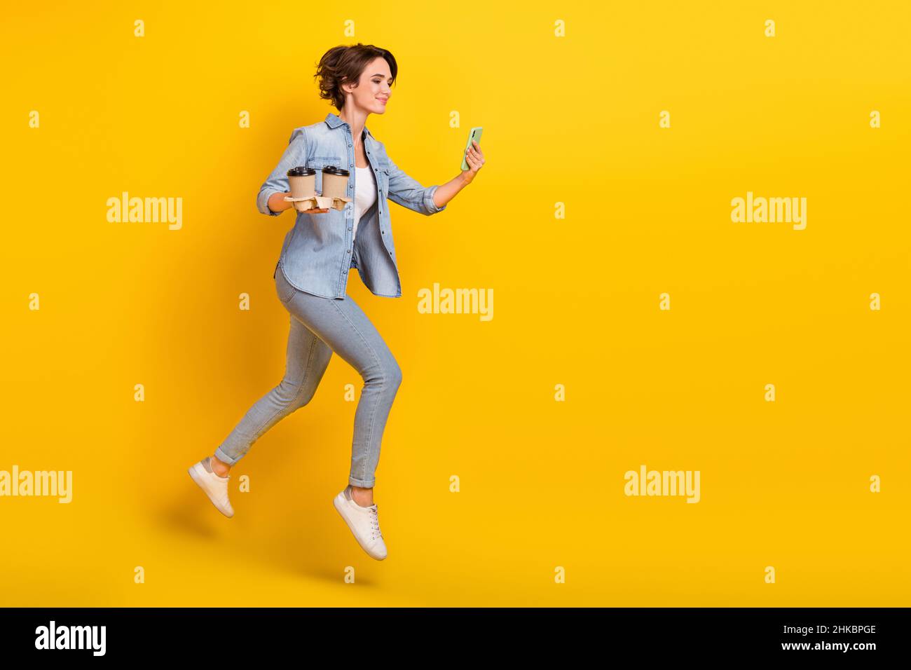 Full body profile side photo of young girl jump hold mobile run ...