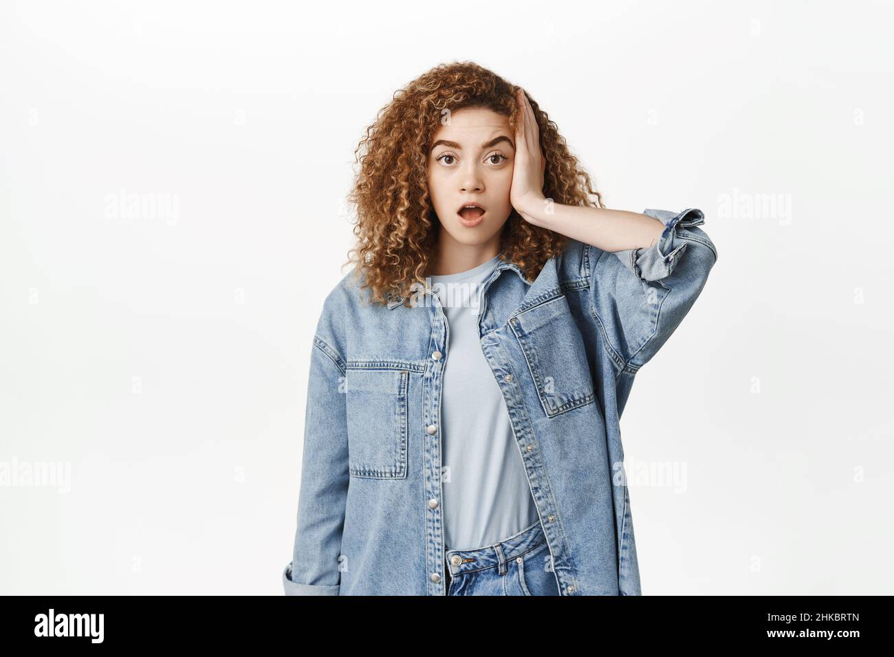 Portrait of shocked and troubled woman facepalm, looking alarmed and ...