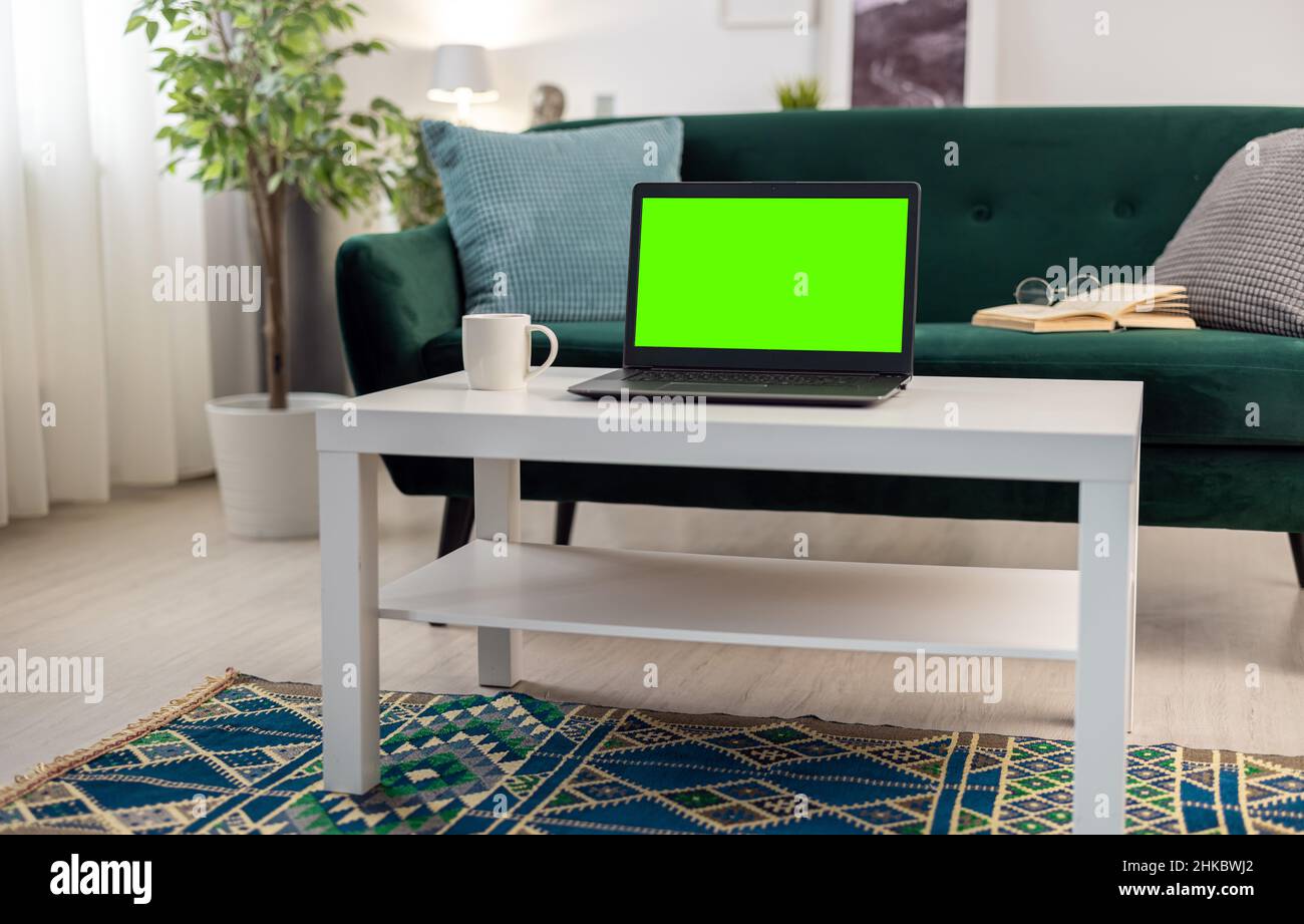 Green screen laptop on table Stock Photo - Alamy