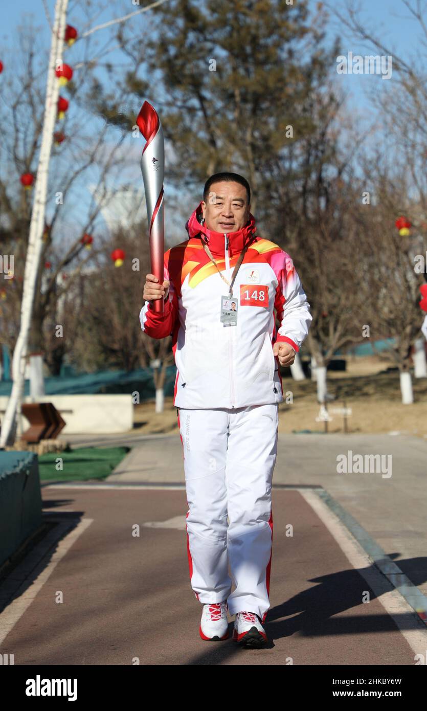 Zhangjiakou, China's Hebei Province. 3rd Feb, 2022. Torch bearer Zhang Chunhui runs with the ...