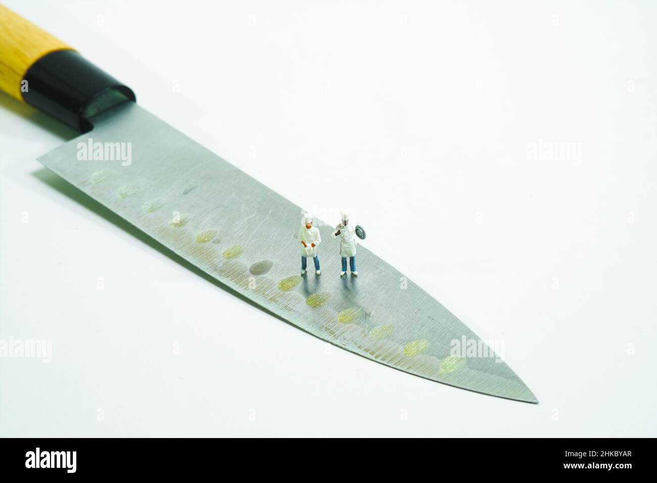chefs standing on a kitchen knife Stock Photo - Alamy