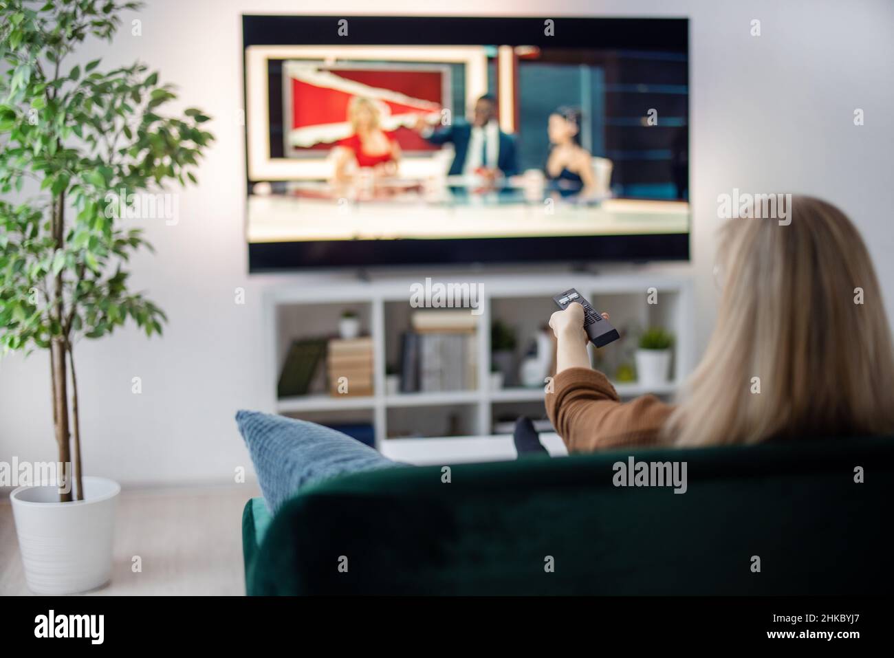Woman watching tv using remote hi-res stock photography and images - Alamy