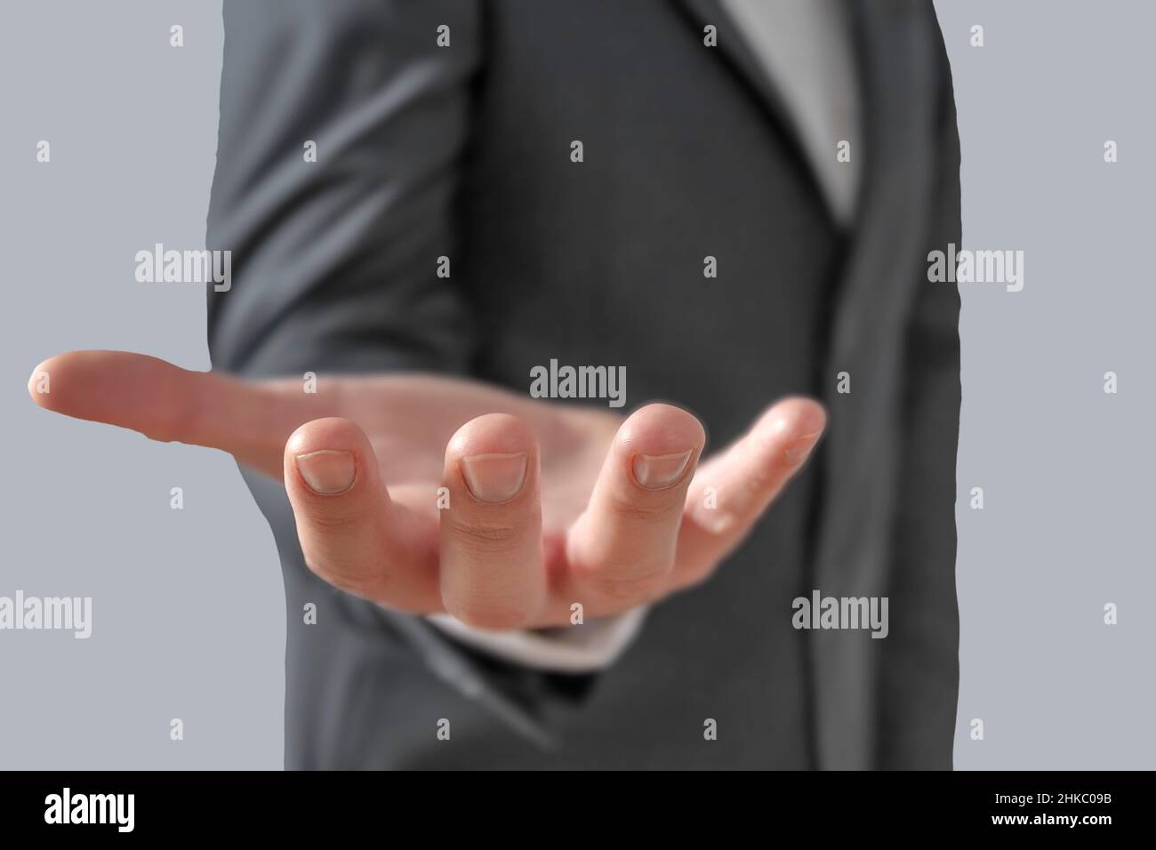 Open palm hand gesture of male hand in suit Stock Photo - Alamy