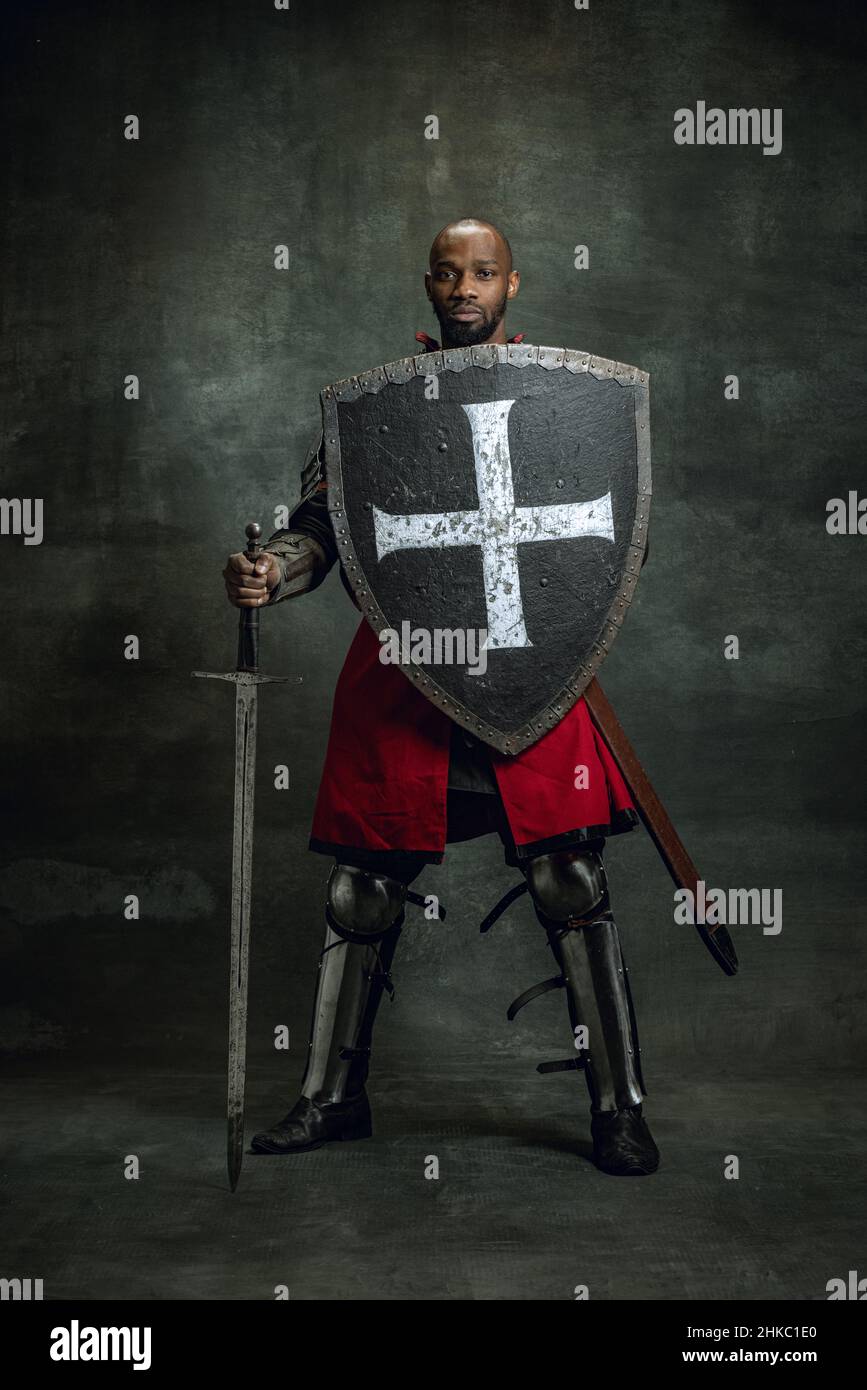 Portrait of medieval warrior, dark skinned bald knight with dirty ...