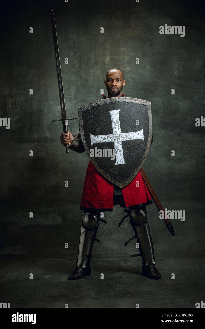 Portrait of medieval warrior, dark skinned bald knight with dirty ...