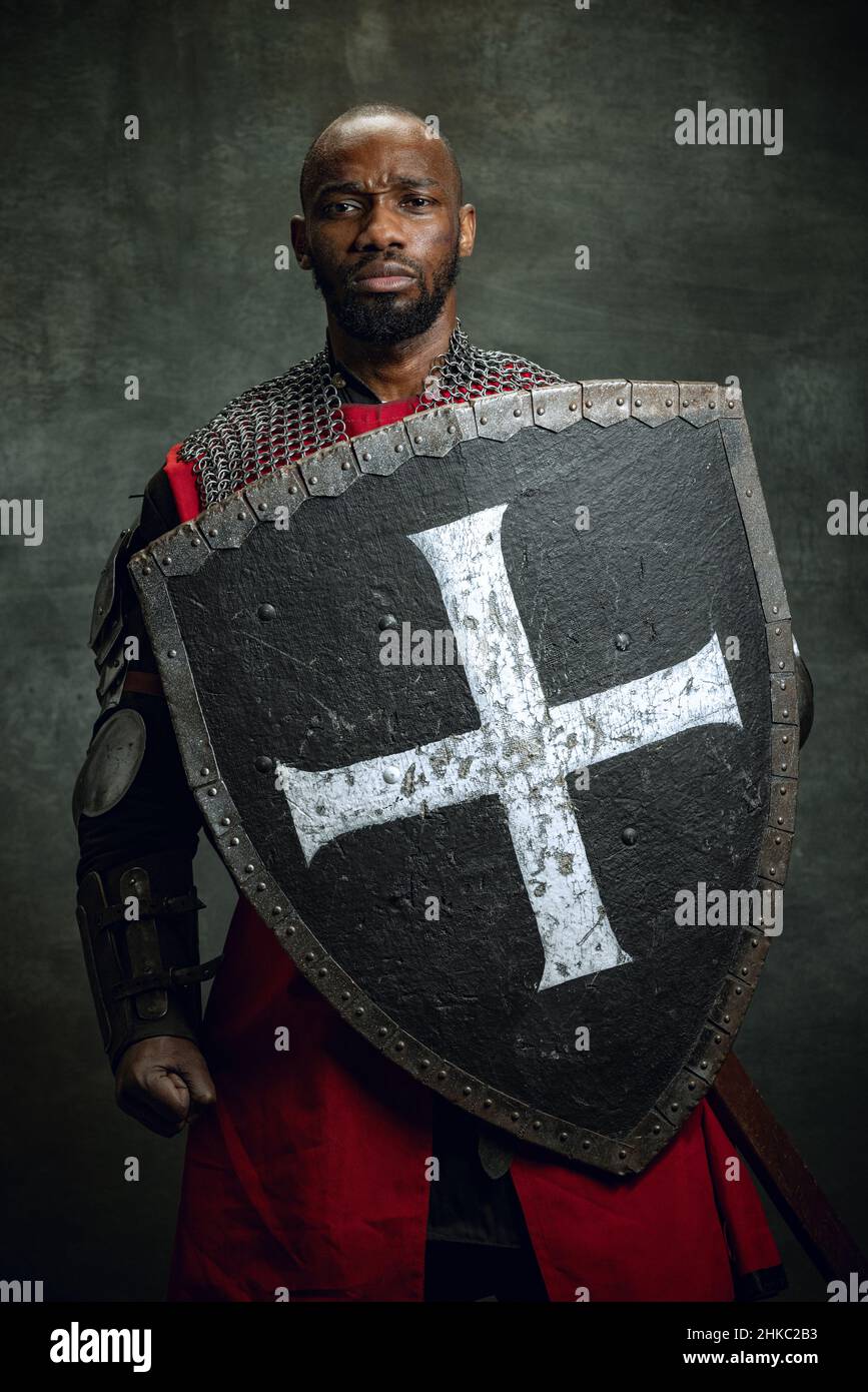 Portrait of medieval warrior, dark skinned bald knight with dirty ...