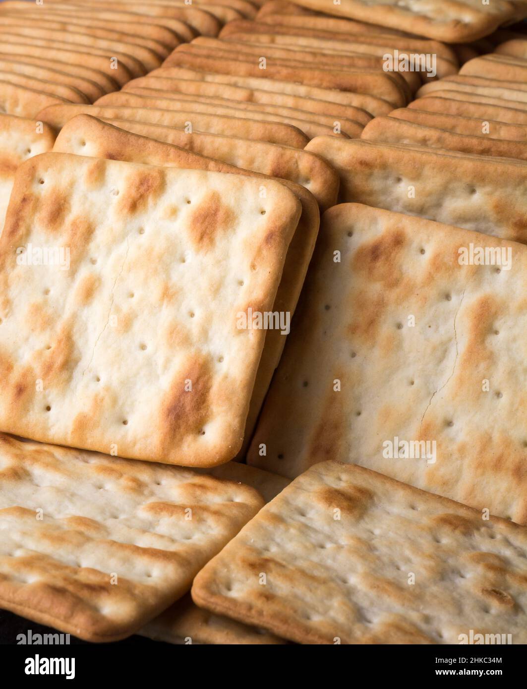 closeup view of biscuits, crispy and crunchy square shape crackers, tea ...