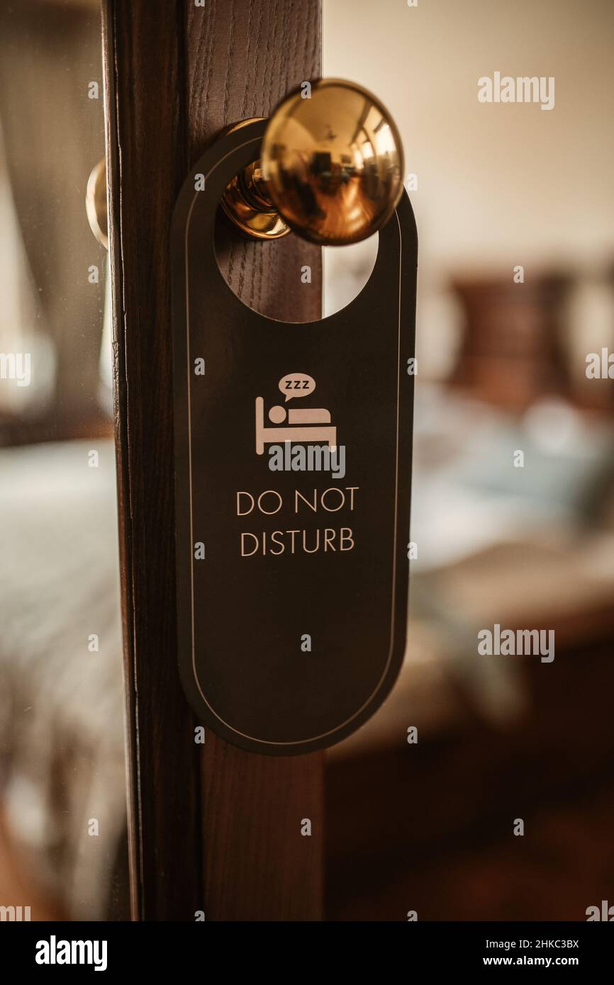 Do not disturb sign at stylish medieval europian hotel door with golden ...