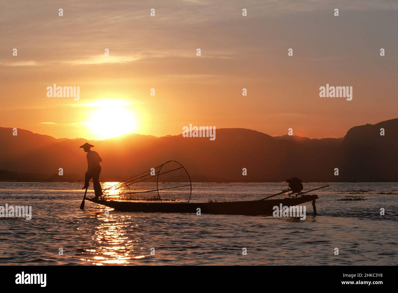 Fisherman silhouette at the sunset on the Inle Lake, Myanmar Stock ...