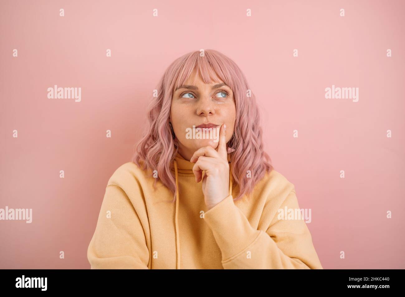 Focused young woman feeling thoughtful thinking an new idea isolated ...