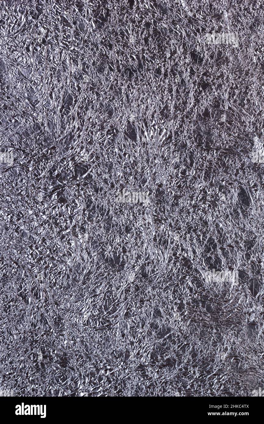 Shiny heavily wrinkled metal silver gray foil vertical texture ...