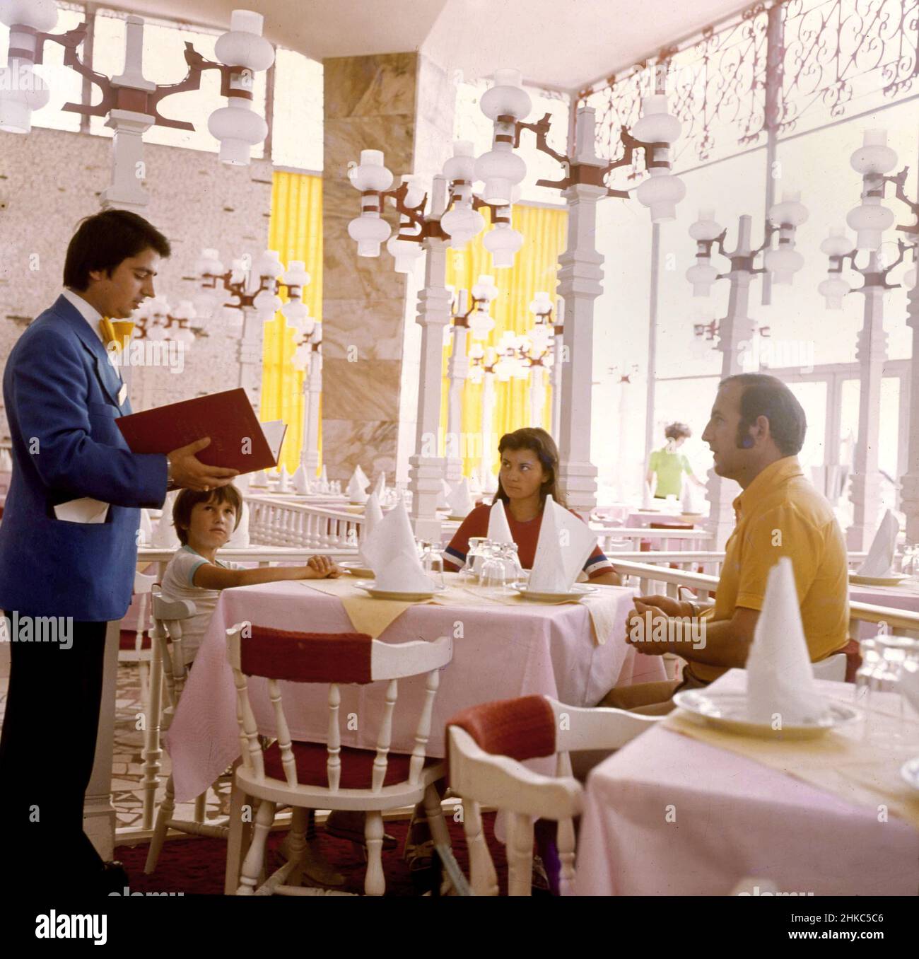Romania, 1974. Family with child at a fancy hotel- restaurant downtown ...