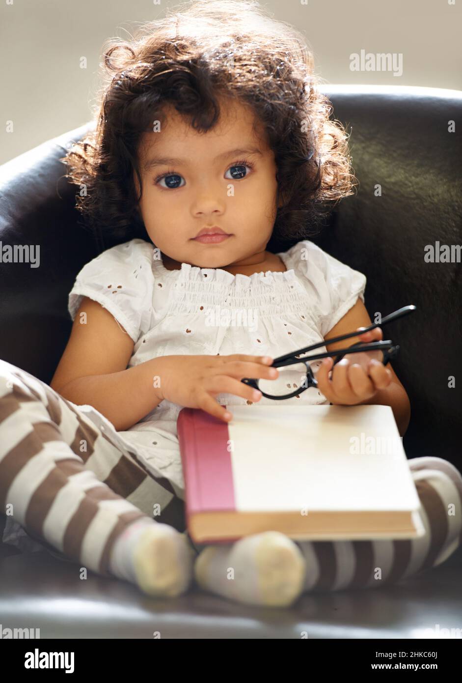 Learning as she grows. Shot of a cute little girl at home Stock Photo ...