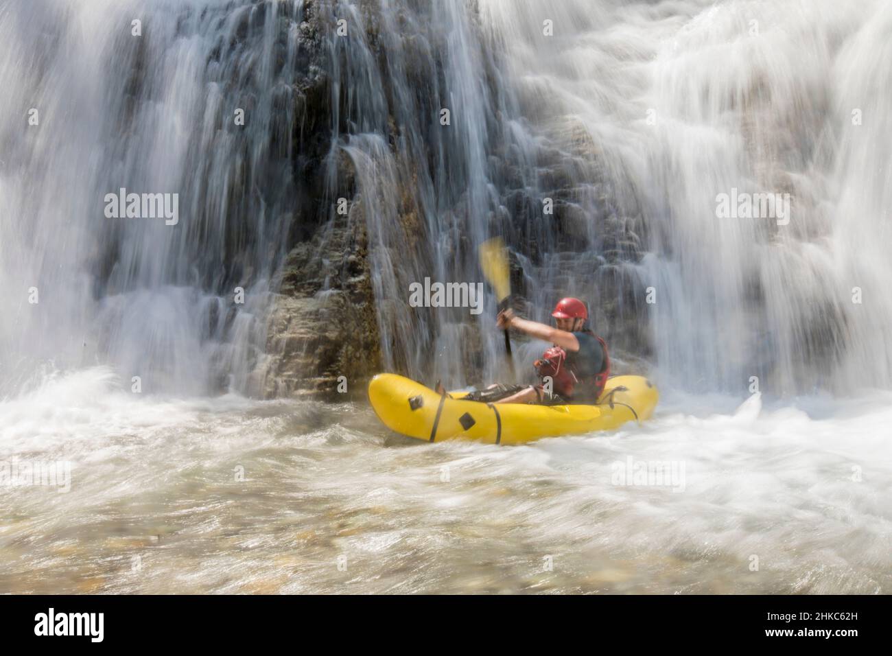 Explorer rafts on river next to waterfall in British Columbia, Canada ...