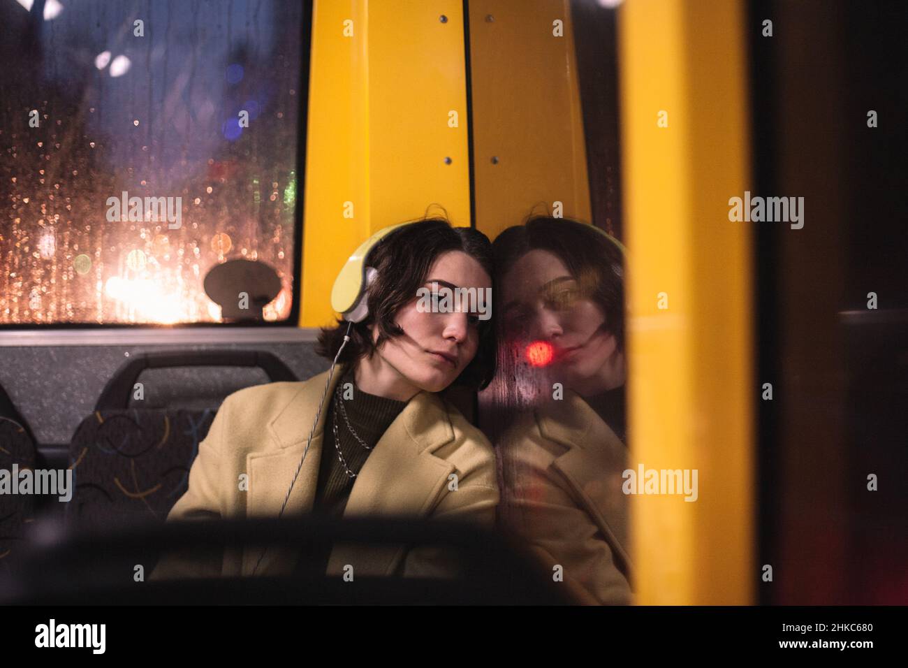Young woman looking through window traveling in trolley bus Stock Photo ...