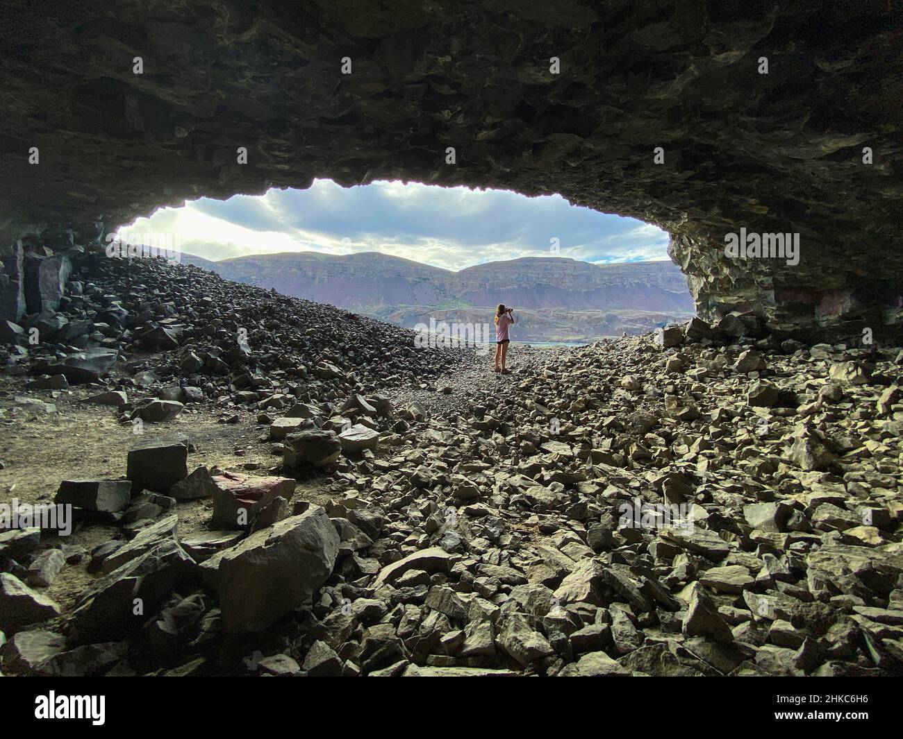 Female photographer taking a photo inside Lenore Caves Stock Photo - Alamy