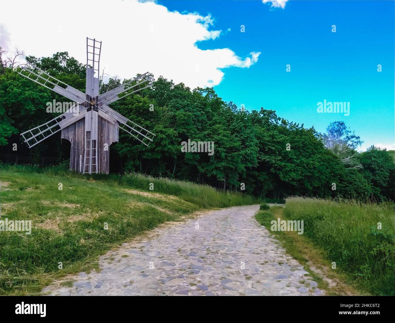 Old windmill by trees on landscape hi-res stock photography and images ...