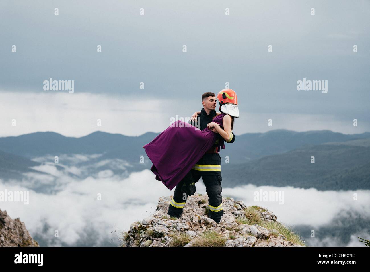 Firefighter Carrying an Woman to Safety Stock Photo - Alamy