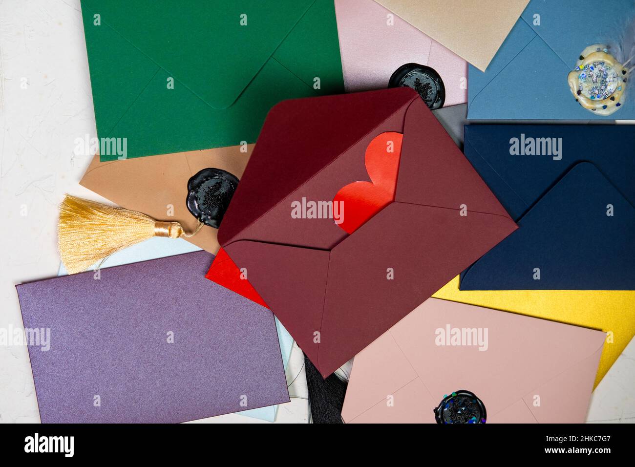 Red heart in an envelope. Lots of colorful envelopes. Envelopes sealed ...