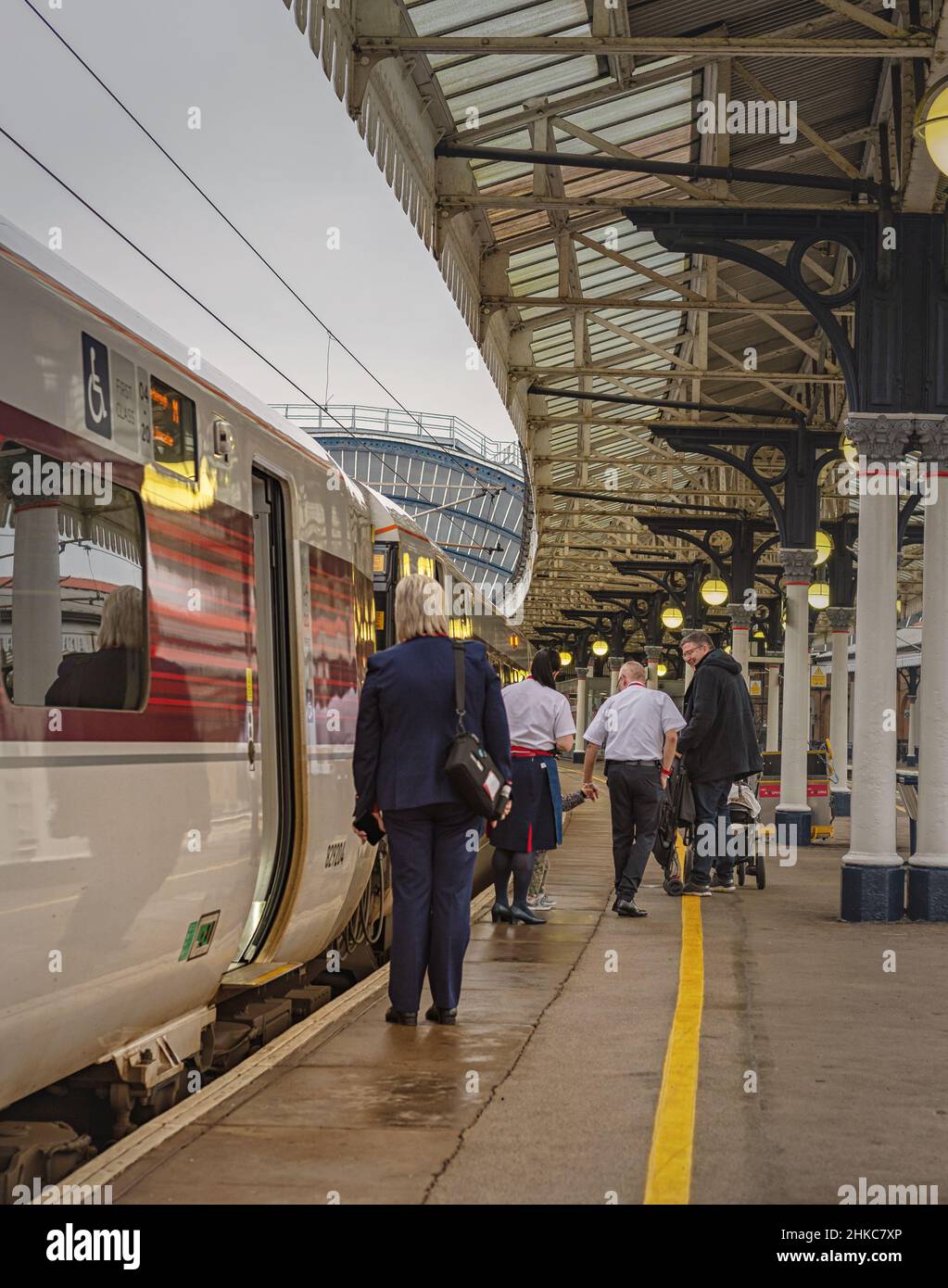 Railway station platform with passengers alighting from a train ...