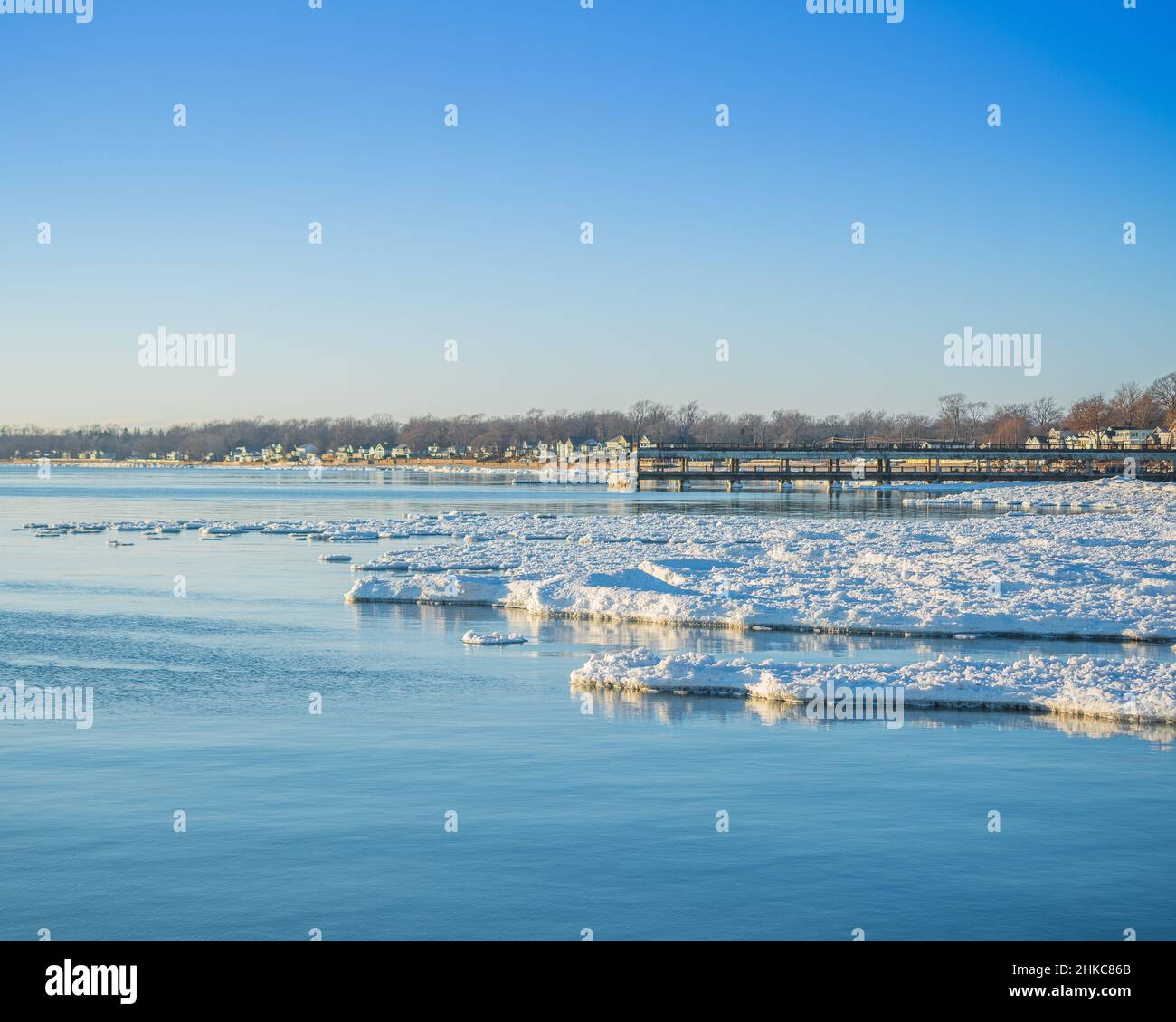 frozen sea with pier in the background Stock Photo - Alamy