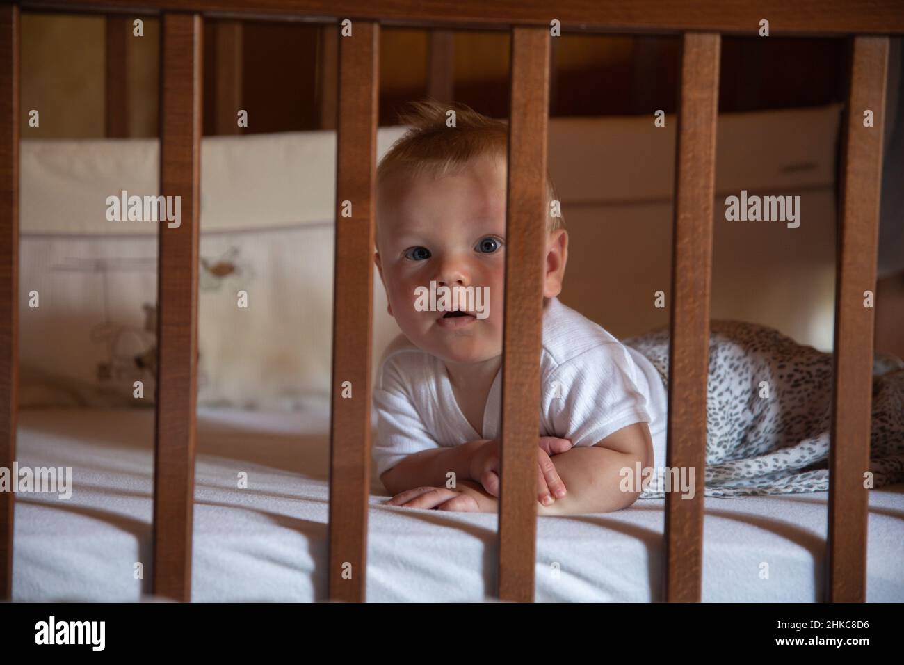 Little boy woke up in his crib Stock Photo - Alamy