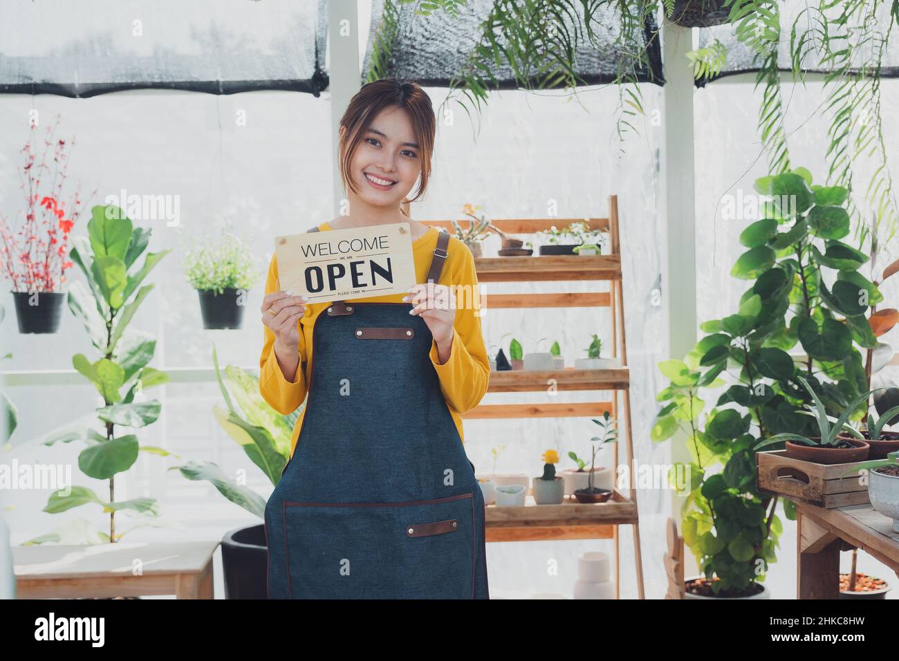 Portrait of cheerful owner standing at market stall Stock Photo - Alamy