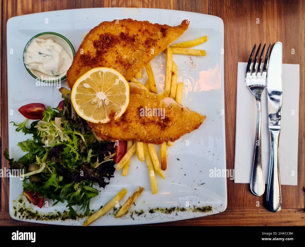Chicken schnitzel menu served with salad. The dinner was served with a ...