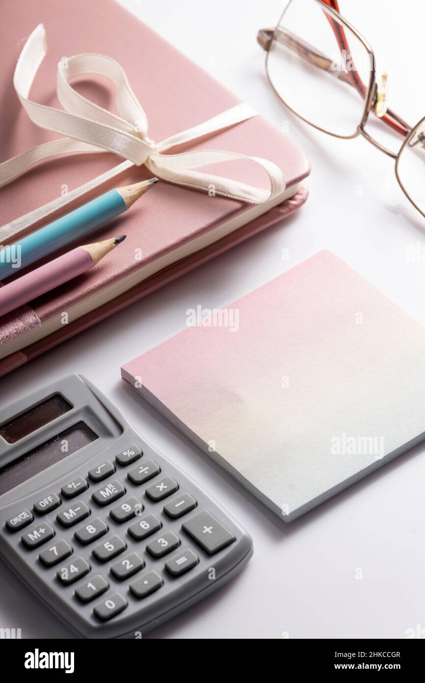 Calculator, glasses, pen and notebook on the table, financial organizer ...
