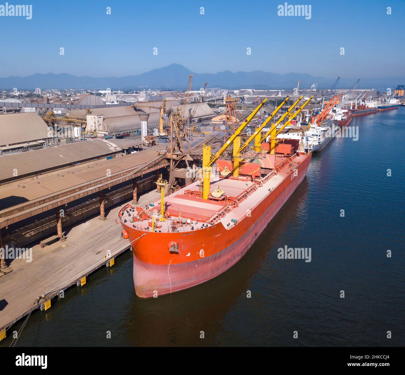 Drone aerial view of red bulk carrier cargo ship loaded with soy at sea ...
