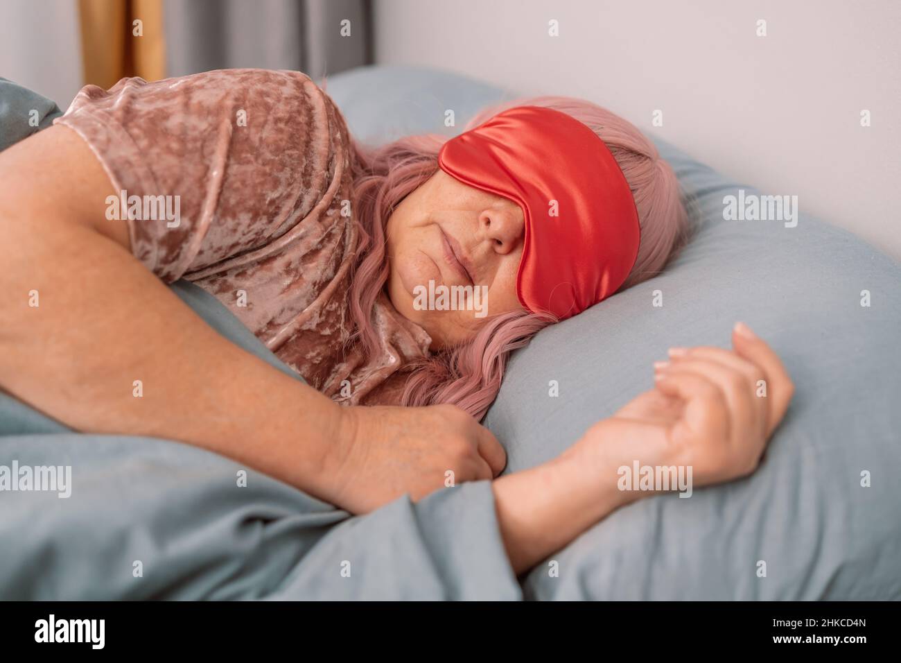 Sweet Dreams. Beautiful 50s woman in eye mask sleeping in bed early in ...