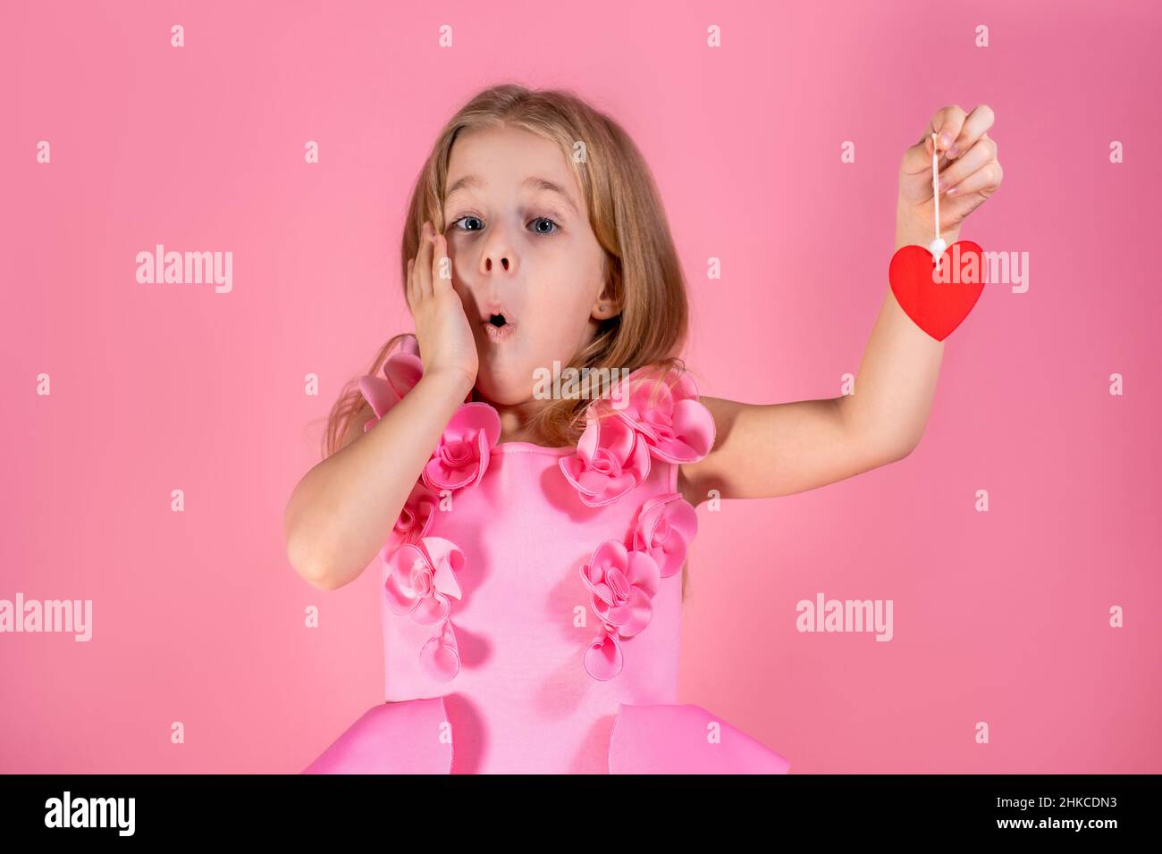 Surprised Cute Little Blue Eyed Girl With Long Fair Hair In Chic Pink Dress Stand Open Mouthed