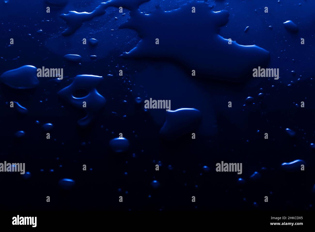 Abstract blue water drops on dark surface Stock Photo - Alamy