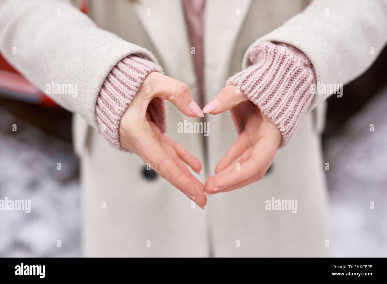 woman holds her hands in shape of heart for gratitude Stock Photo - Alamy