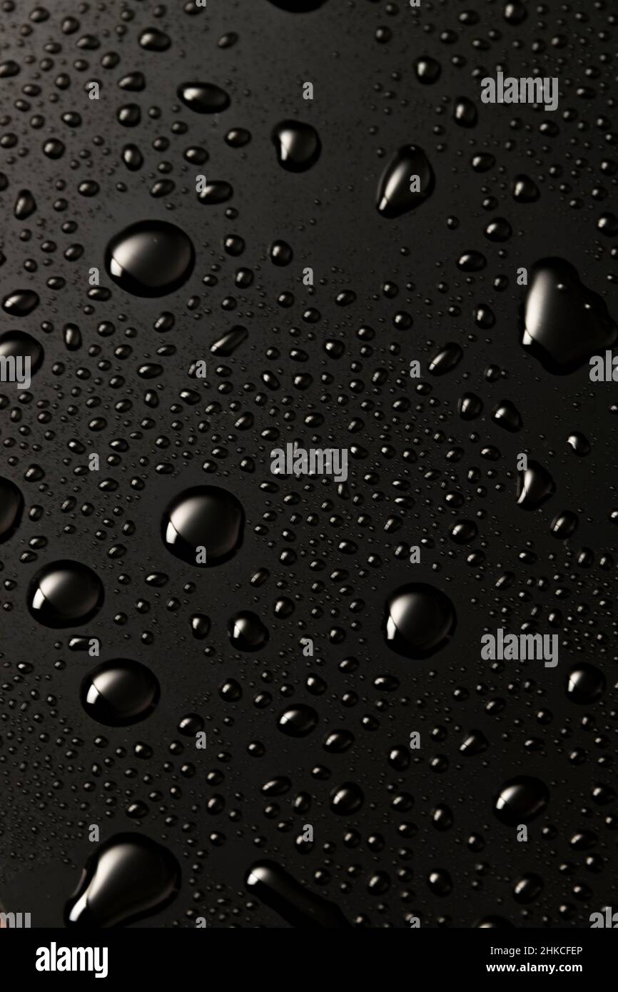 Black metal water drops on dark reflective surface Stock Photo - Alamy